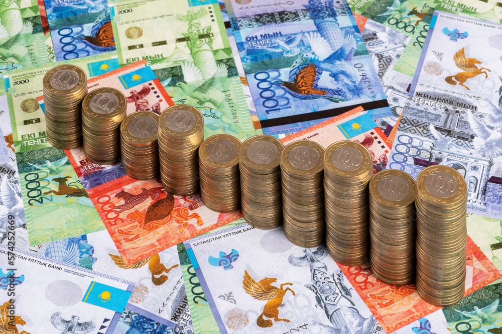 Columns of many coins in denominations of 100 Kazakhstani tenge against ...