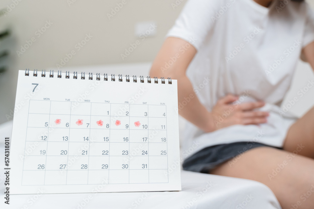Monthly menstruation symptom period concept. Close up calendar marking ...