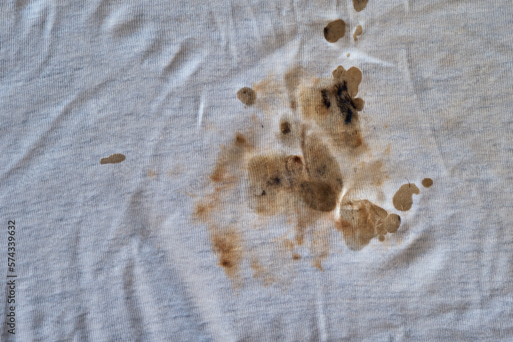 Texture of old dirty torn t-shirt with black-brown spots. Off-white ...