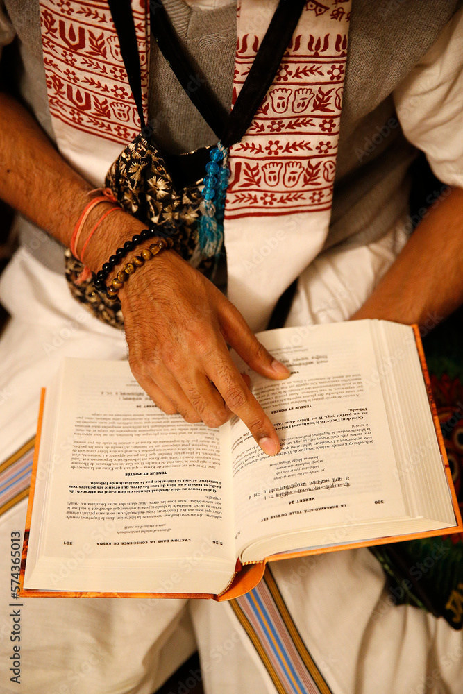 Gita Jayanti celebration in an ISKCON temple. Devotee reading the ...