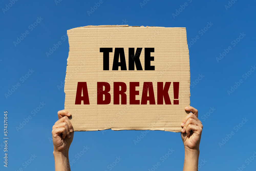 Take a break text on box paper held by 2 hands with isolated blue sky ...