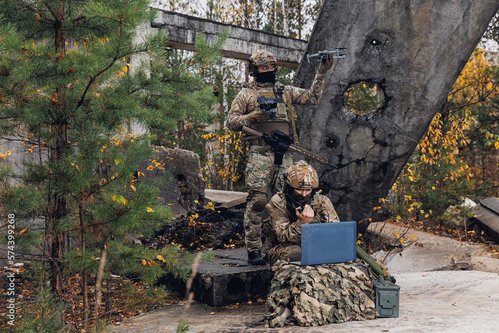 Concept smart war robots. Soldier engineer use laptop for transmits ...