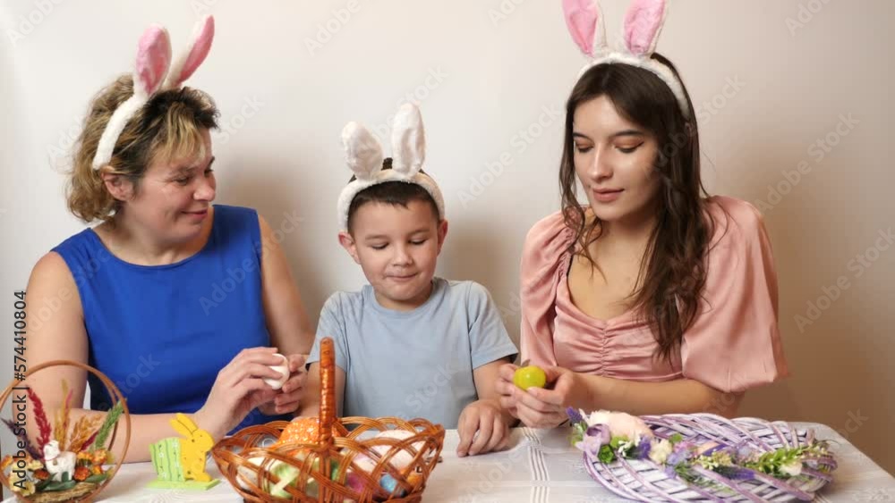 Mother, son and daughter are treated to an Easter chocolate egg. Celebrating Easter in the ...