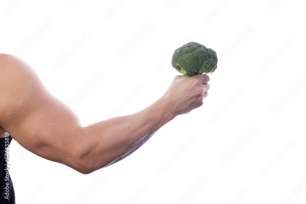 Strong, fit, muscular man holding broccoli in his right hand, with his ...