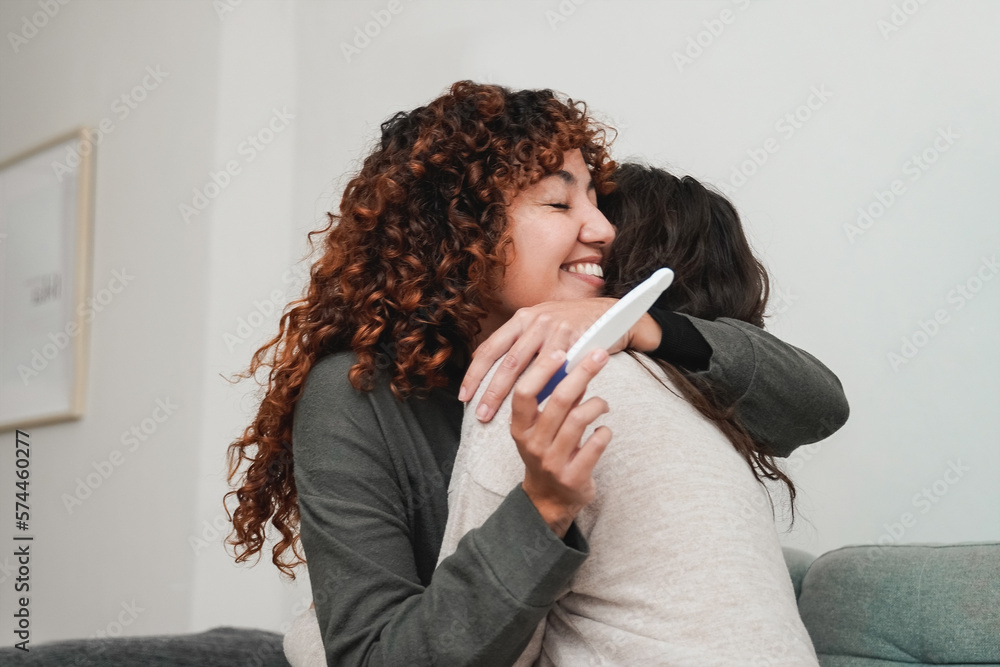 Gay female fertility: Lesbian couple celebrating with pregnancy test at ...