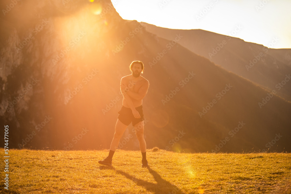 Man boxing with shadow exercising at sunset outdoor. Port victory ...