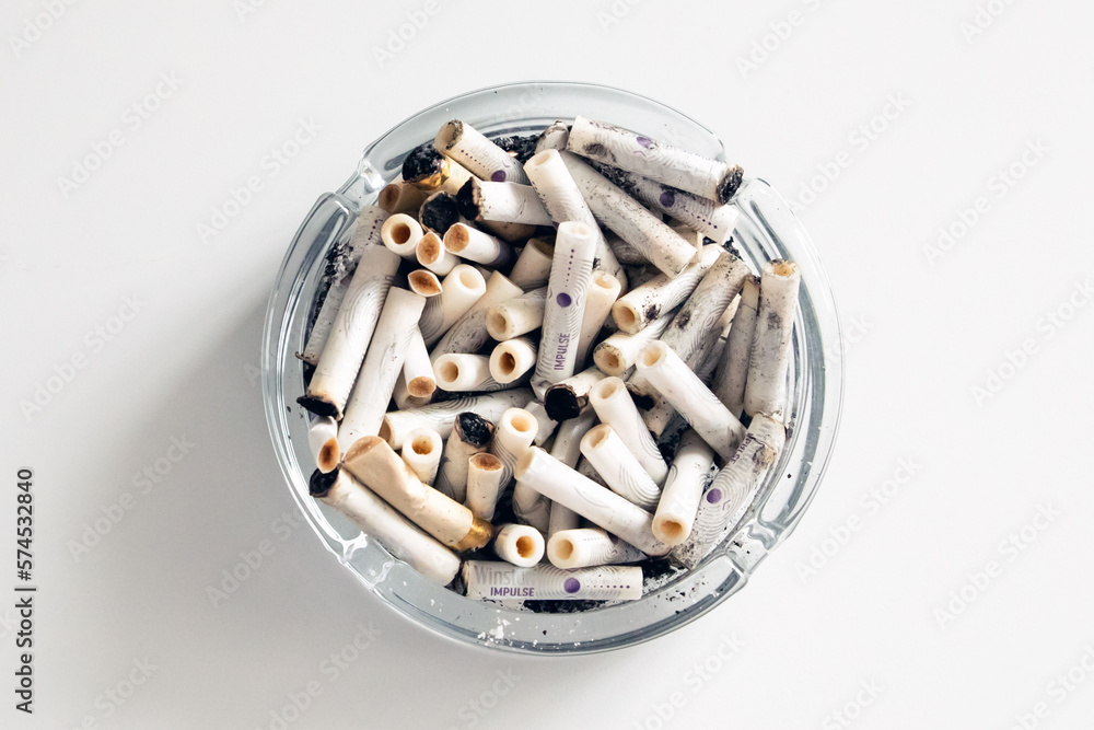 Smoked cigarettes Winston impulse in glass ashtray on white background ...