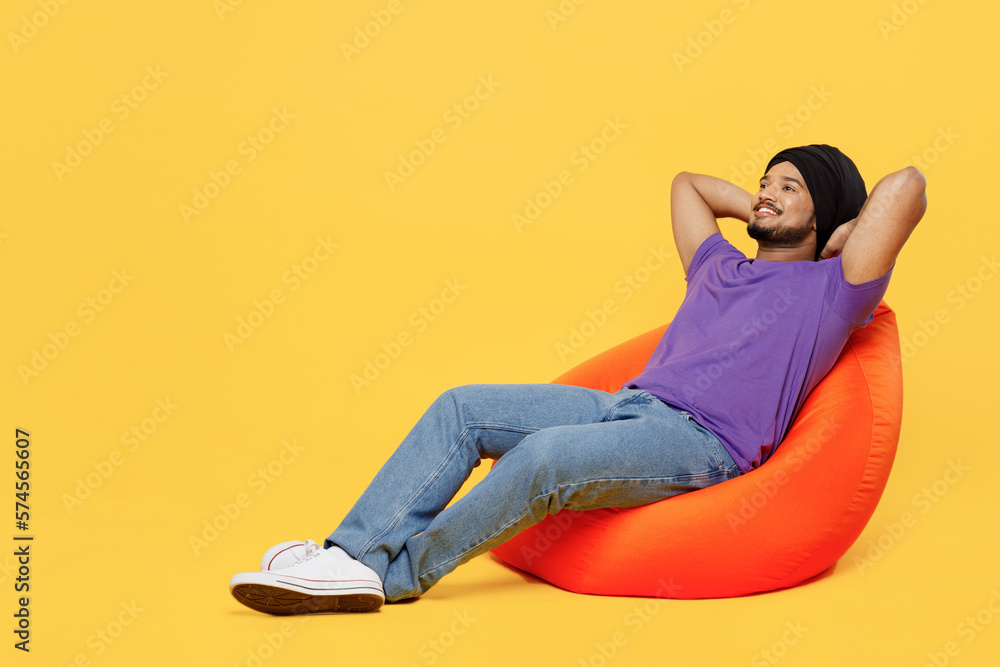 Full body side view minded devotee Sikh Indian man ties his traditional ...