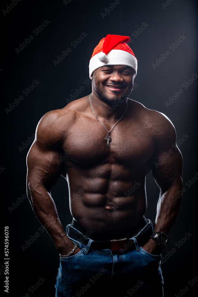 Sexy bodybuilding santa in studio. Young shirtless muscular macho with ...