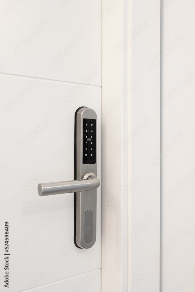 Entrance white wooden door with an electronic lock for the security of ...