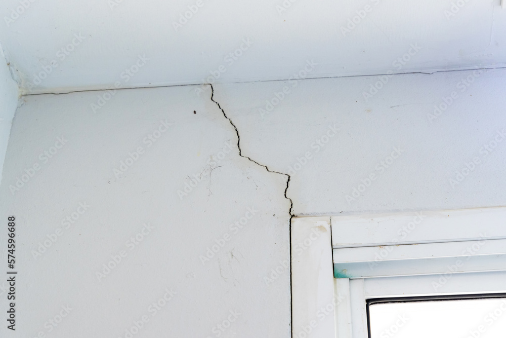 Wall crack near window frame in house or office interior building. Wall ...
