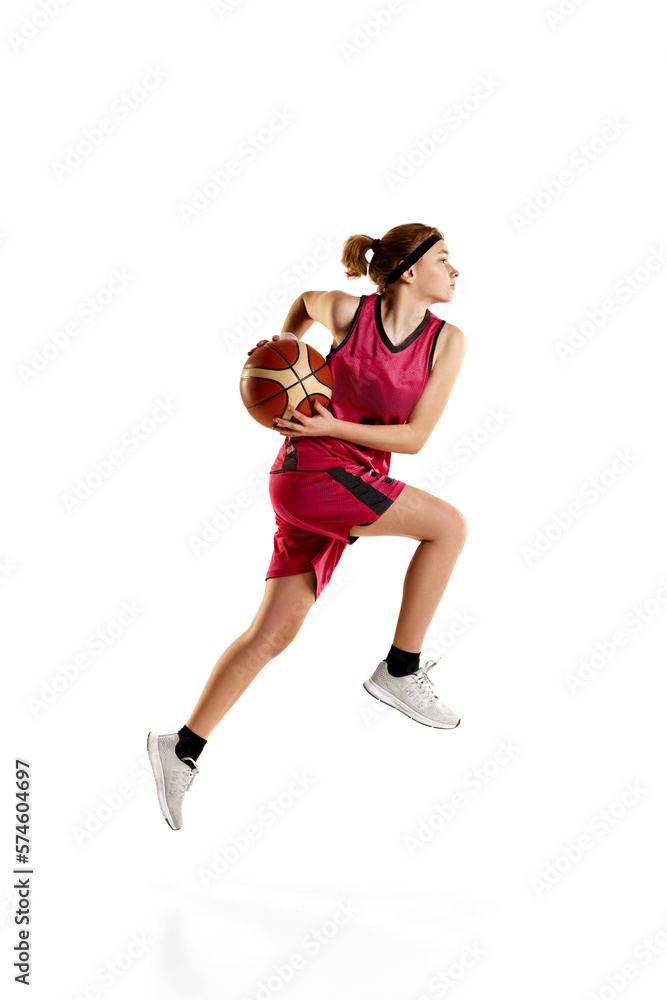 Dynamic portrait of young, teen girl, basketball player in motion ...