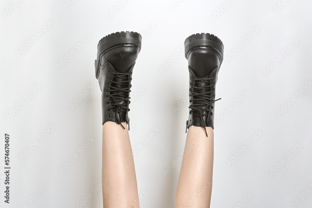 Woman legs in black combat boots on high heel platform with lug soles ...