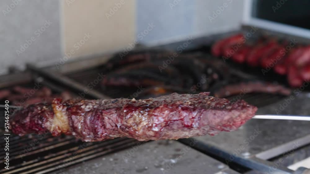 Traditional Churrasco Brazilian Barbecue on a skewer in slow motion ...