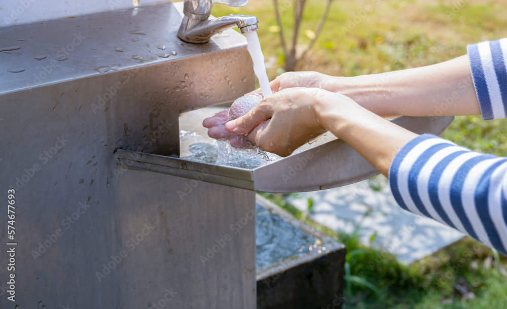 World water day concept. Woman washing hands with tap water under ...