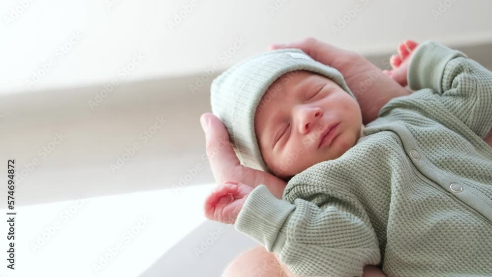 Few days old caucasian newborn baby in male hands. Happy Fathers day ...