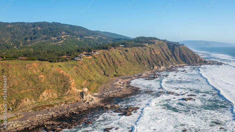 aerial horizontal drone photo from the sea towards the fishermen cove ...