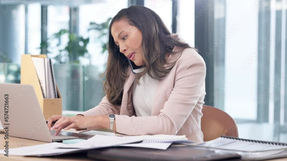 Female advertising agent looking busy while talking on a phone call and ...