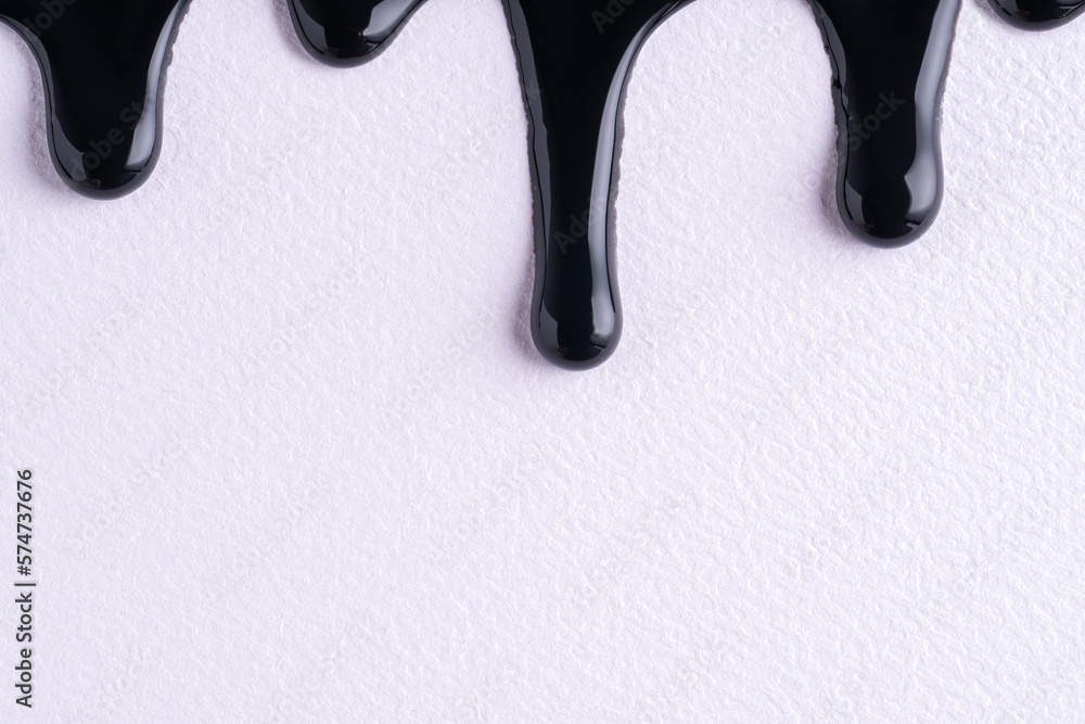 Black liquid drops of paint color flow down on white canvas. Abstract ...