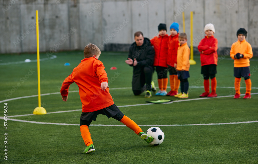 Little boy, child, football player in uniforma training outdoor at ...