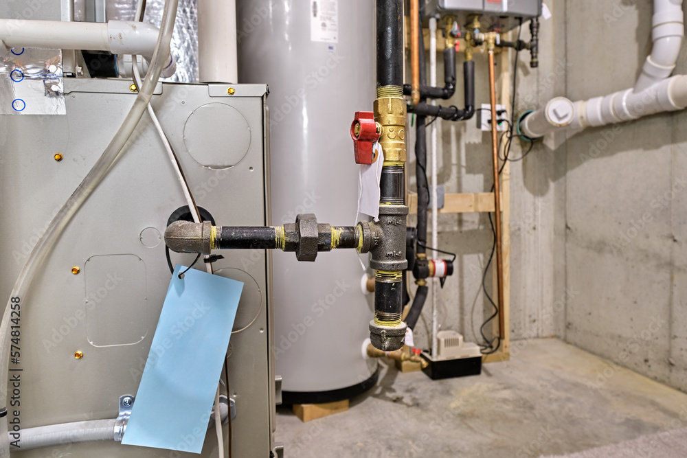 Furnace gas line and shutoff valve in concrete basement mechanical room ...