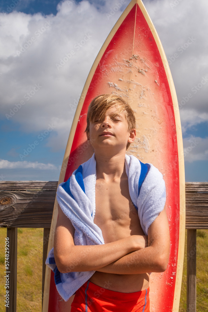 Youth Preteen Boy Leaning Against Surfboard with Towel on Sunny ...