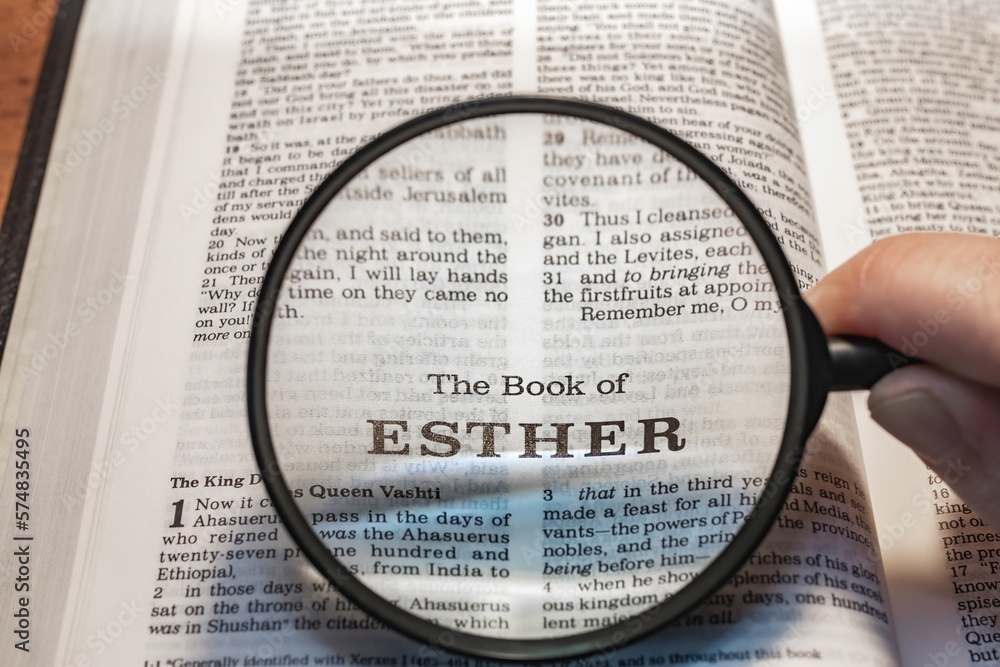 title page book of esther close up using magnifying glass in the bible ...