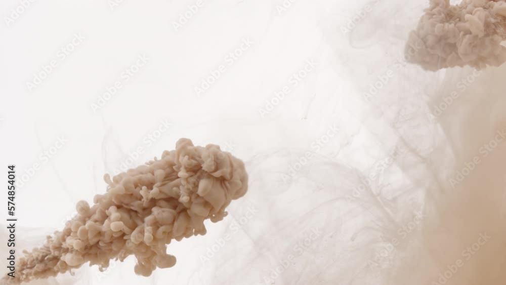 Beige ink is being injected in water with beige stain from two ...