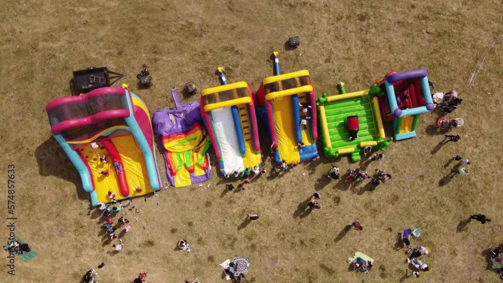 Top down aerial view of kids playing in inflatable playground Stock ビデオ ...
