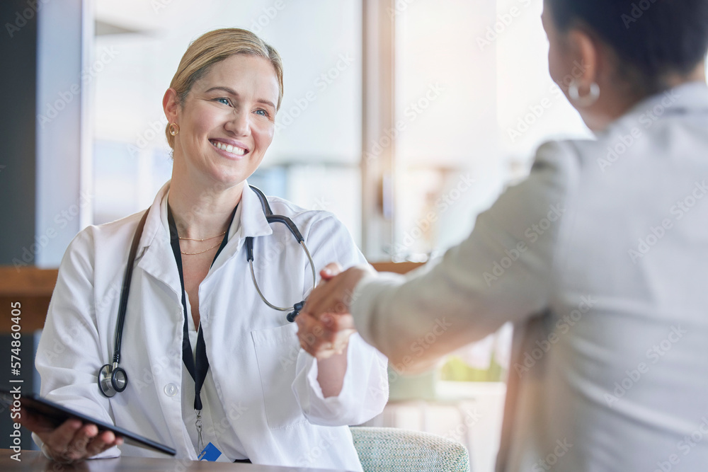 Handshake, healthcare or trust with a doctor woman and patient in a ...