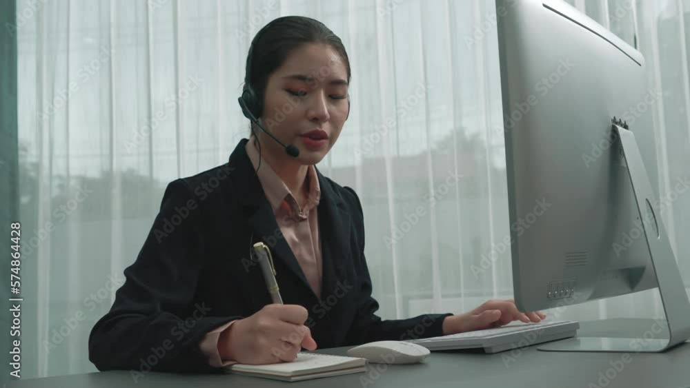 Asian customer support operator wearing headset and microphone working ...
