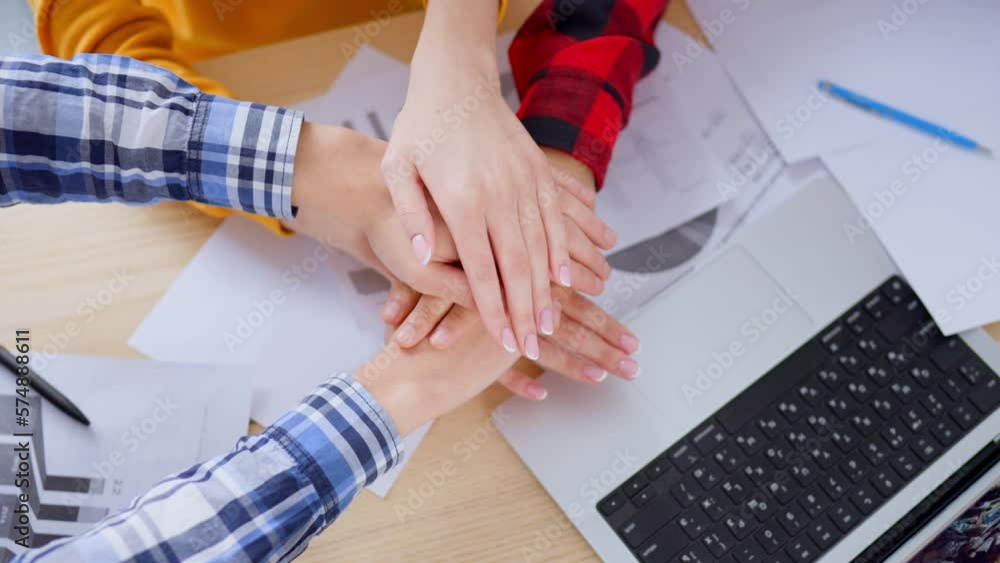 Many handshake of young business people join hug team work in office ...