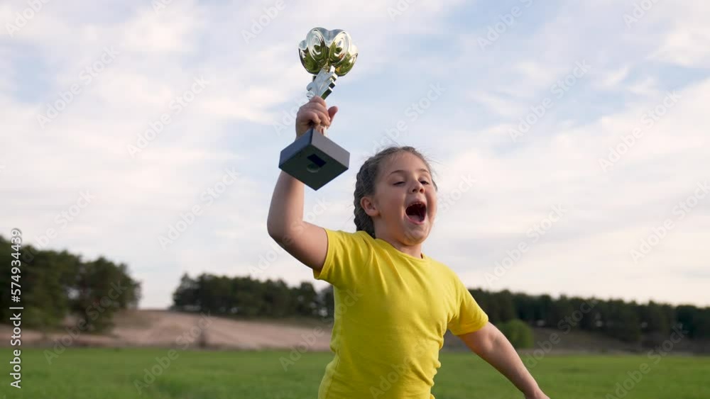 Winner child silhouette. Kid with cup of success raises her hand ...