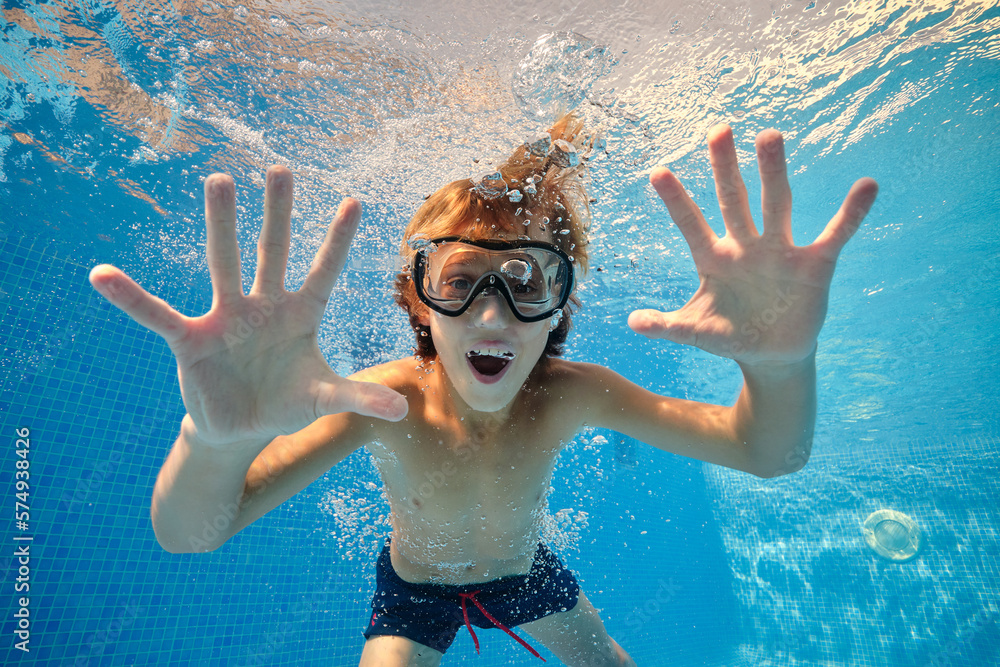 Excited boy showing palms in swimming pool Stock Photo | Adobe Stock
