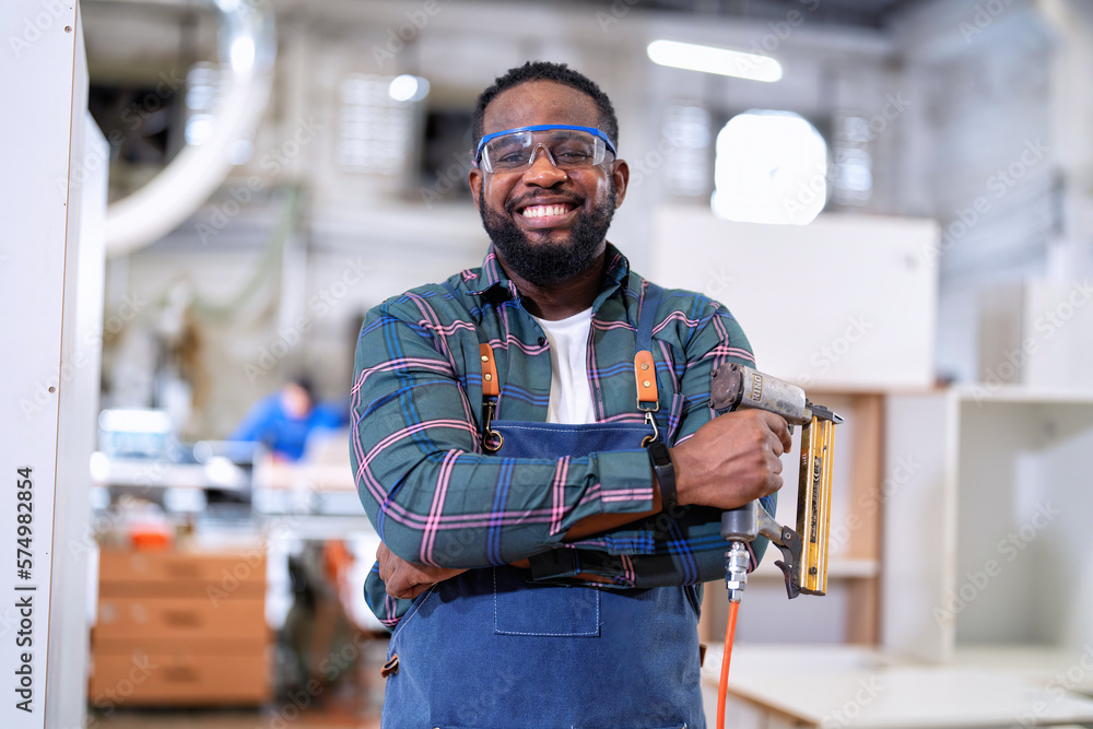 In work place carpenter man working using pneumatic nail gun stand ...