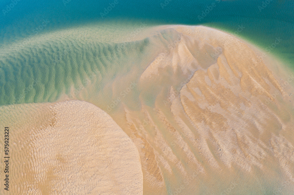 Aerial view of ripples in tidal sand bars in blue sea water Stock Photo ...