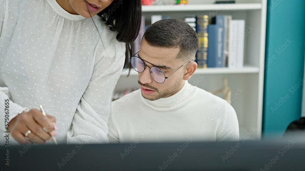 Man and woman student and teacher using computer studying at university ...