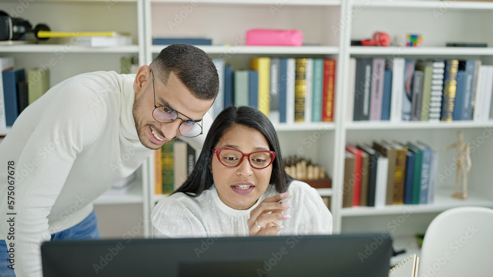 Man and woman student and teacher using computer studying at university ...