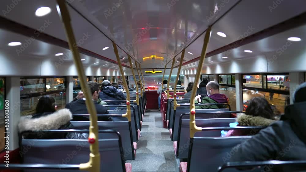 Back of bus with passengers at night in London traditional ...