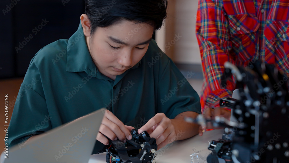 student is trying put his finger in finger loop robotic hand, that ...
