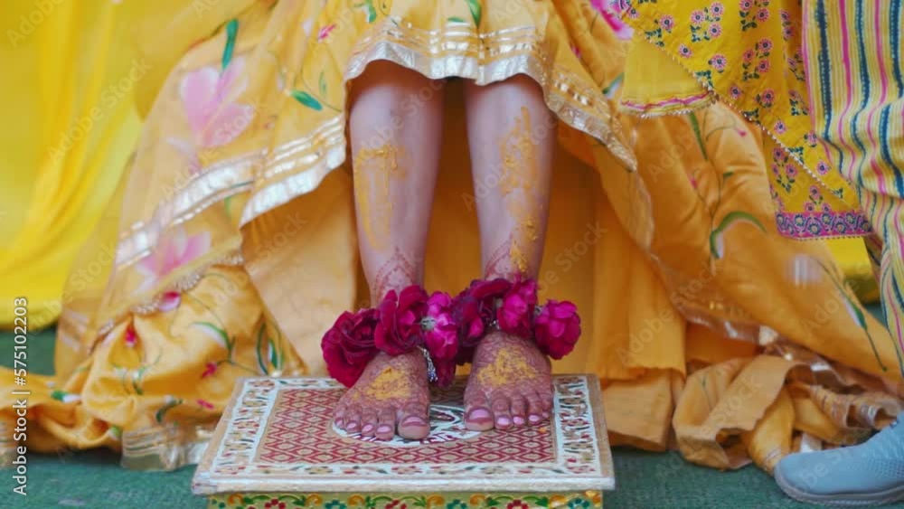 Close up shot of Indian bride's legs covered with turmeric. An Indian ...