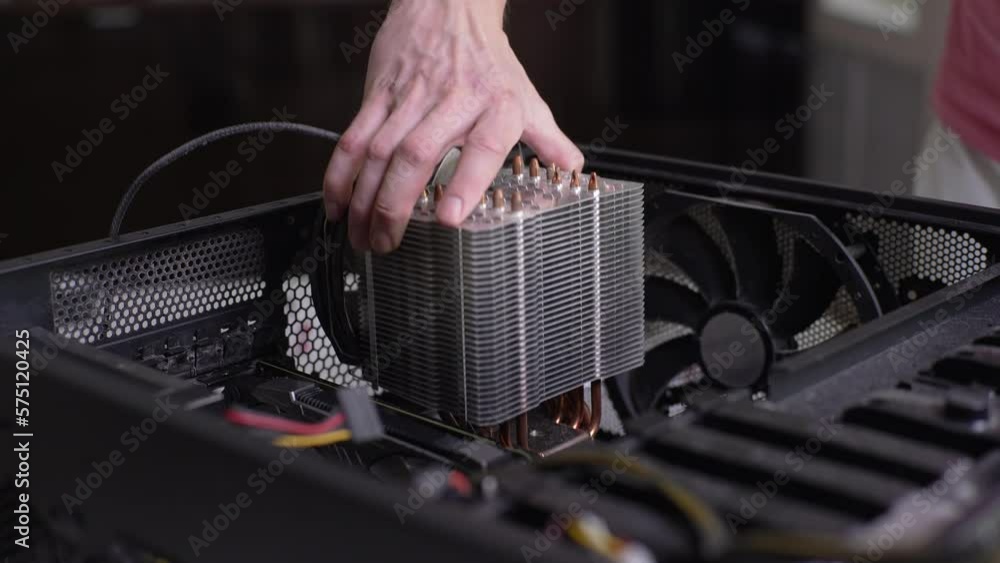 Extreme close-up of unrecognizable male master removing PC CPU air ...