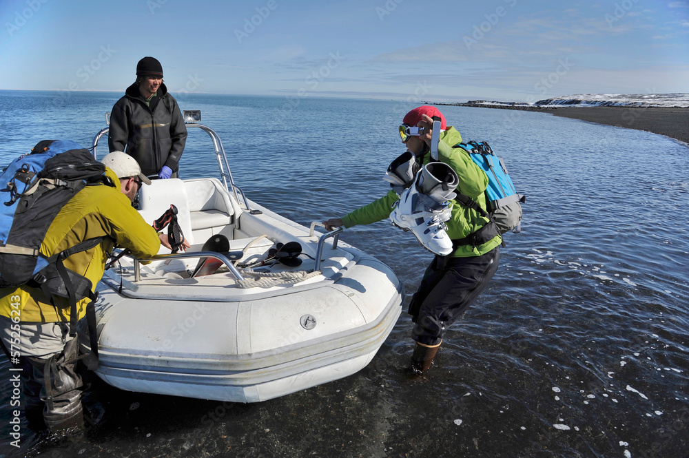 Skiers load a skiff for the return to the 58-foot Alaskan Seiner M/V ...
