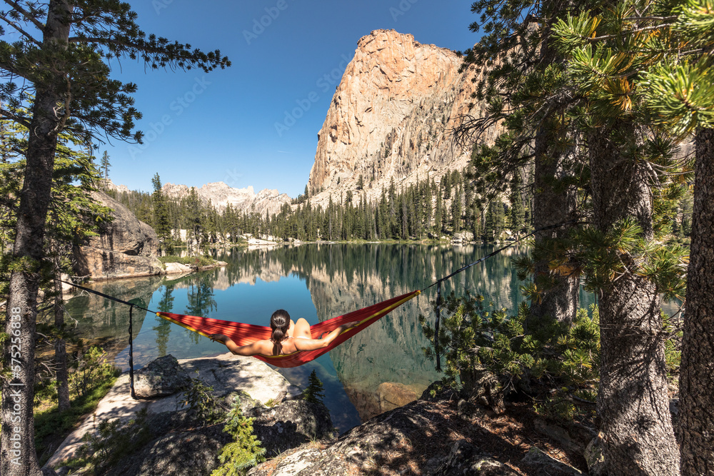 Foto Stock Female hiker relaxing in hammock between two pine trees ...