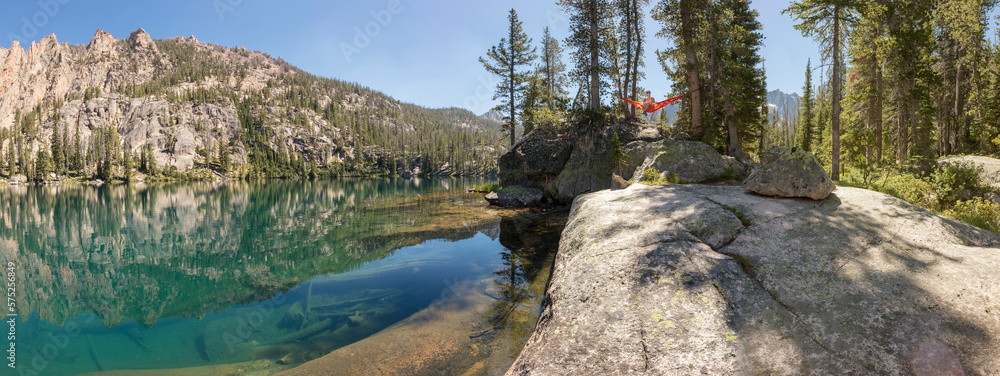 Foto de Female hiker relaxing in hammock between two pine trees ...