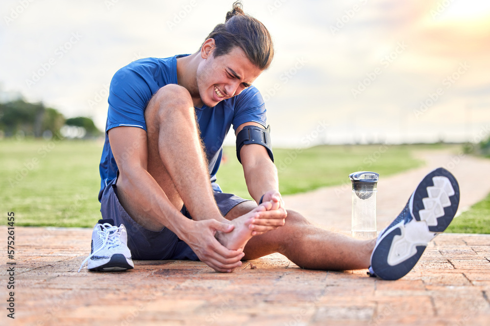 Fitness, injury and foot pain with man in park for muscle spasm ...