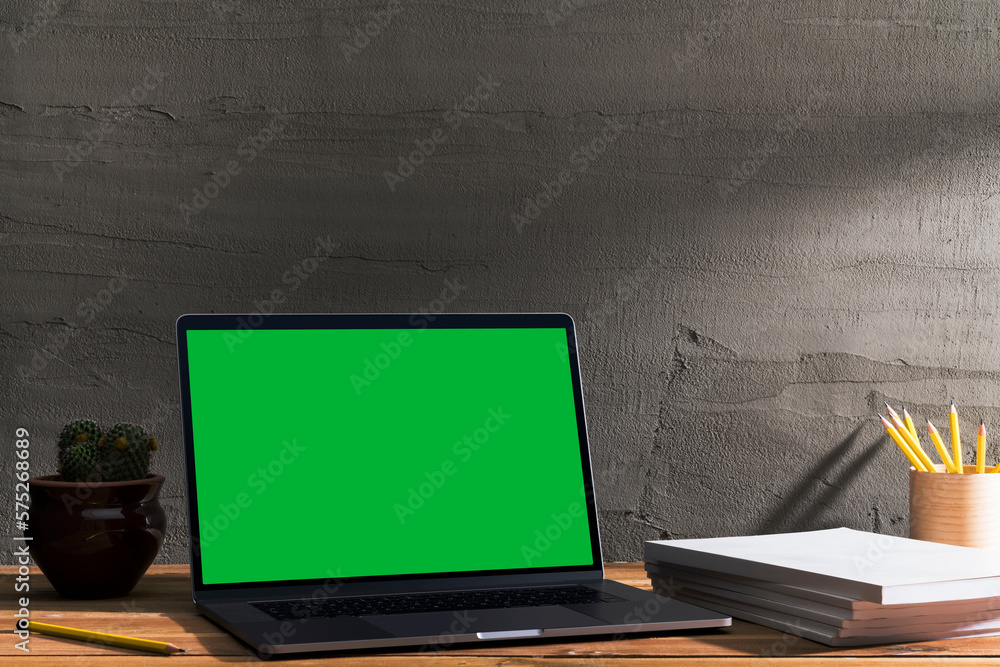 Chroma key green screen, angled view laptop on table with blank cover ...