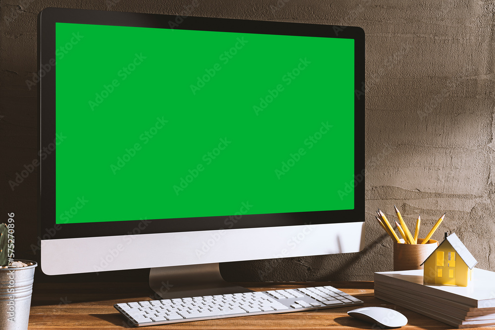 Chroma key green screen, angled view computer on table with white cover ...