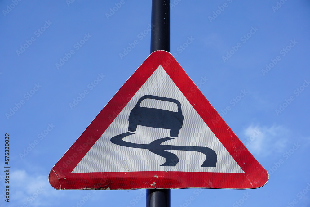 slippery road warning sign. triangular road sign indicating wet ...
