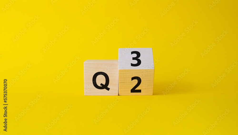 From 2nd Quarter to 3rd symbol. Turned wooden cube with words 2nd Quarter and 3rd Quarter ...